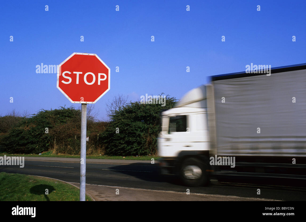 lorry passing stop sign at road junction near Leeds Yorkshire UK Stock ...