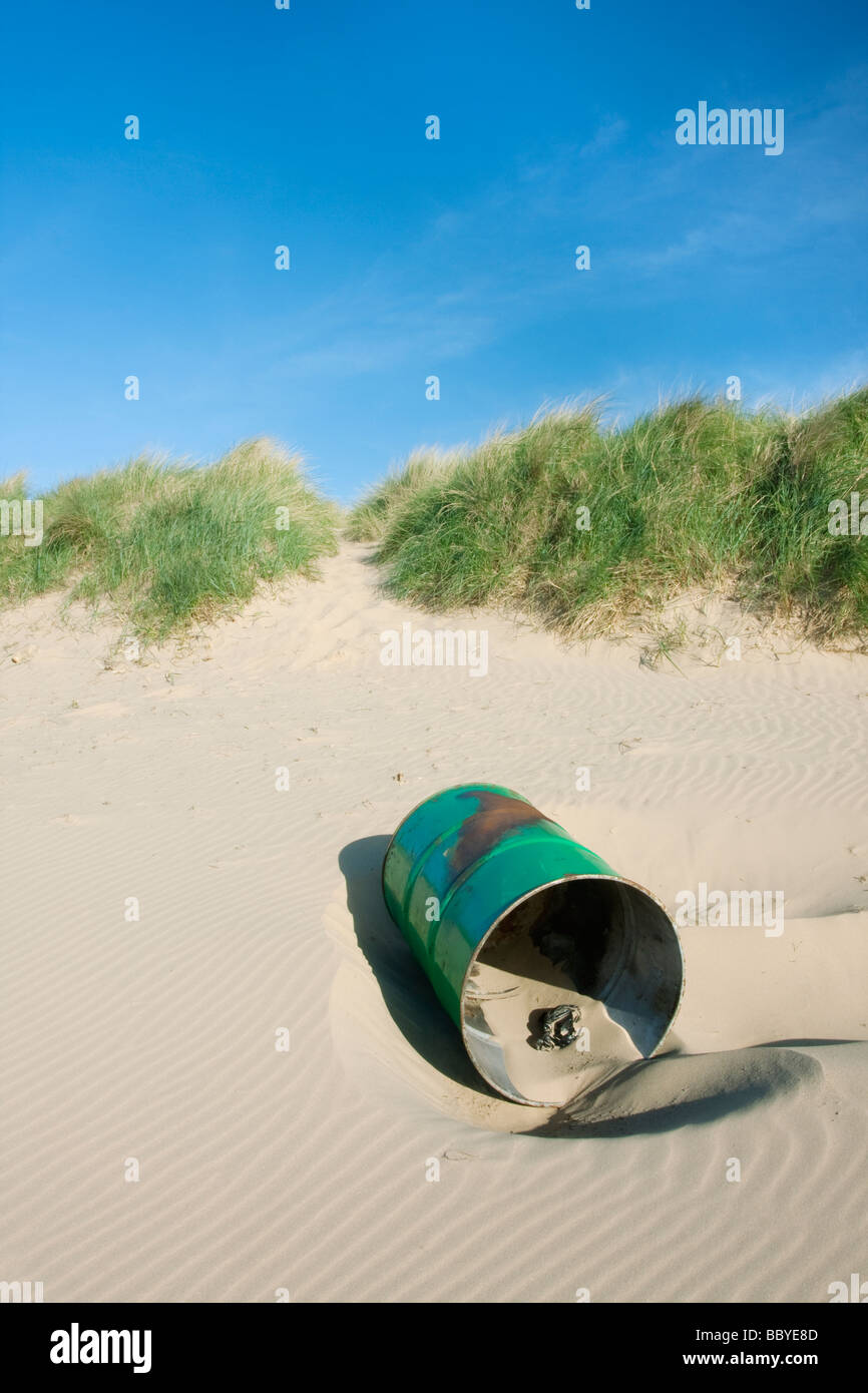 An abandoned oil drum lays washed up on the sand on the Dunes between ...