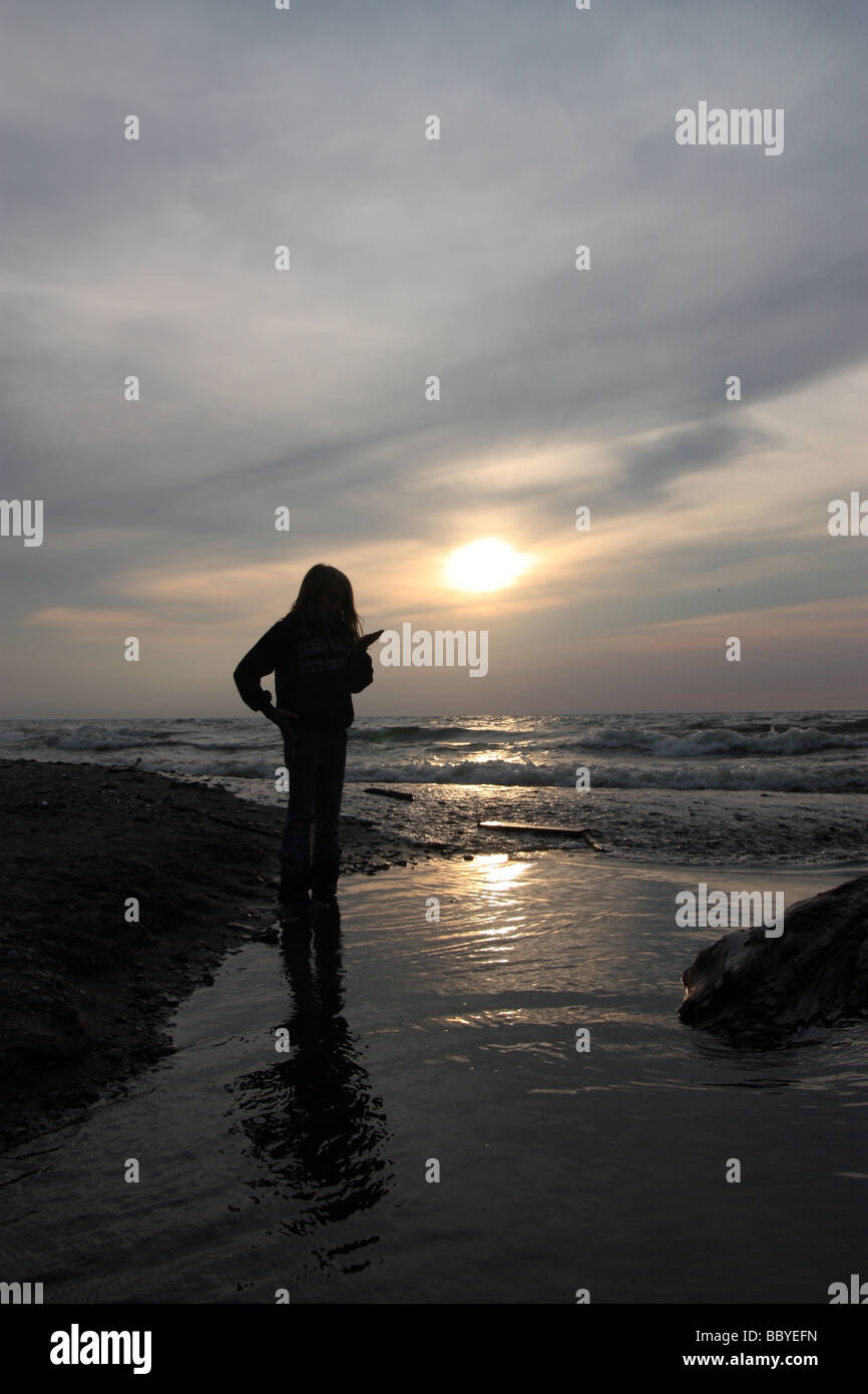 Girl fishing alone by stream Stock Photo - Alamy