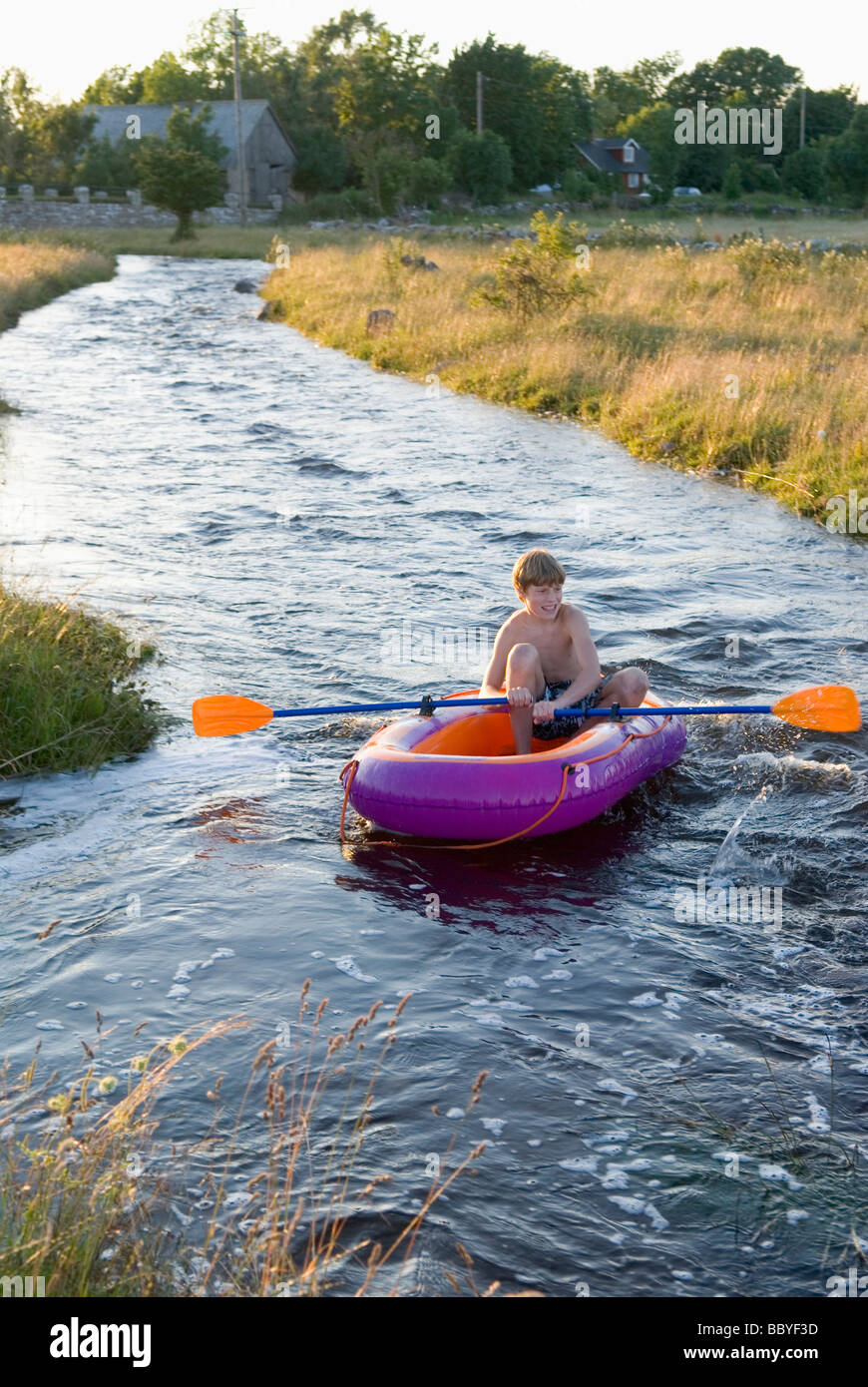 Young boy in a plactic boat, rowing in a stream Stock Photo - Alamy