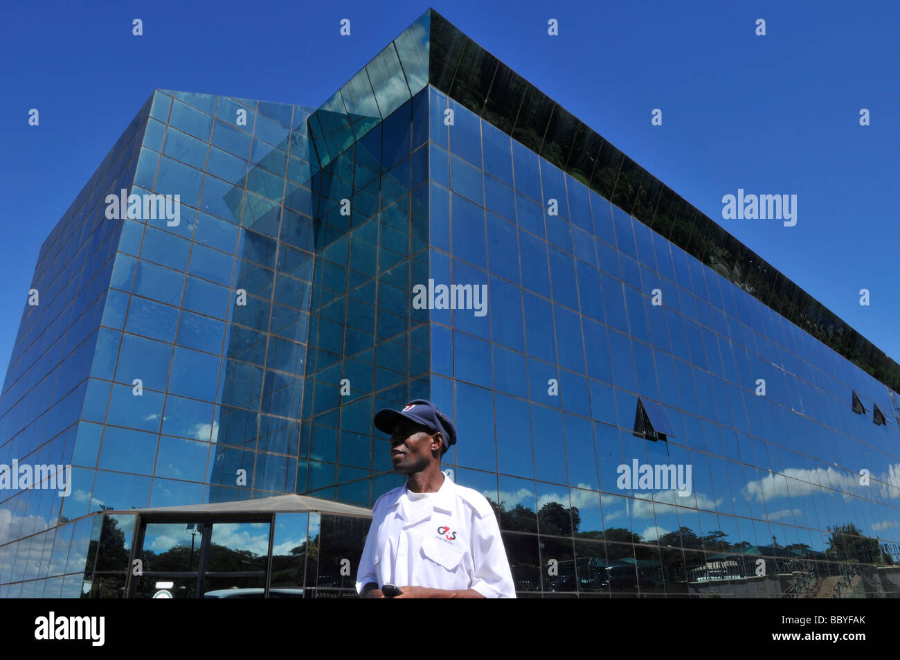 Security guard stands in front of the glassed Petroda Building in ...