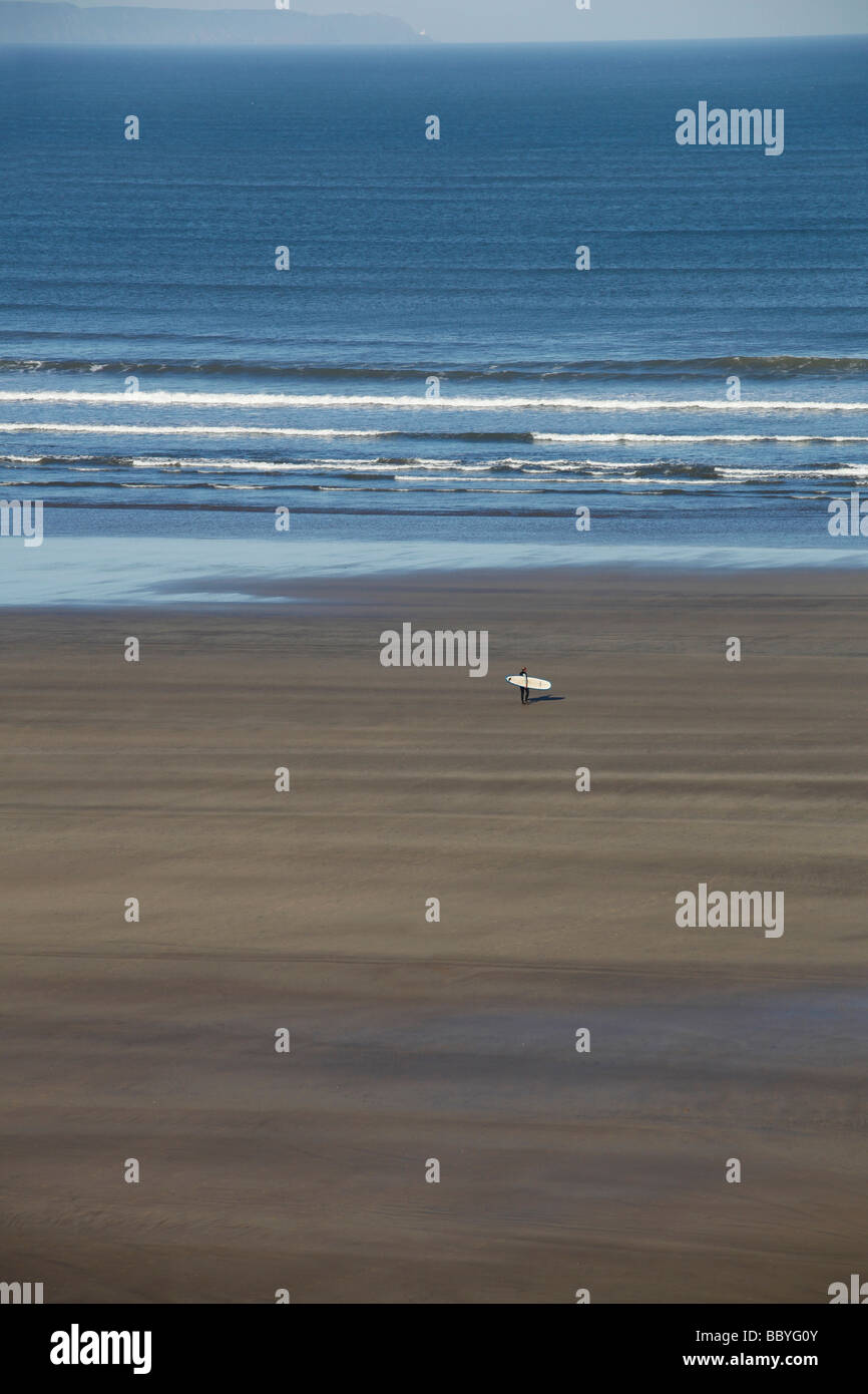Surfers walking across the beach towards the sea Stock Photo - Alamy