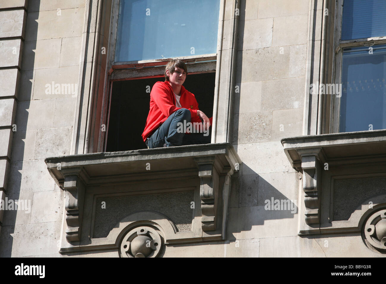 onlookers in a building in london city center looking out of a window ...