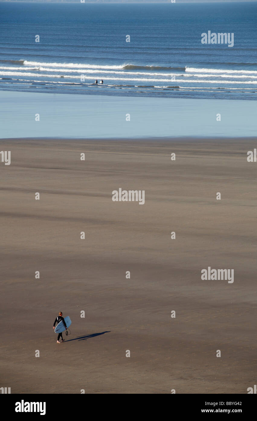 Surfers walking across the beach towards the sea Stock Photo - Alamy