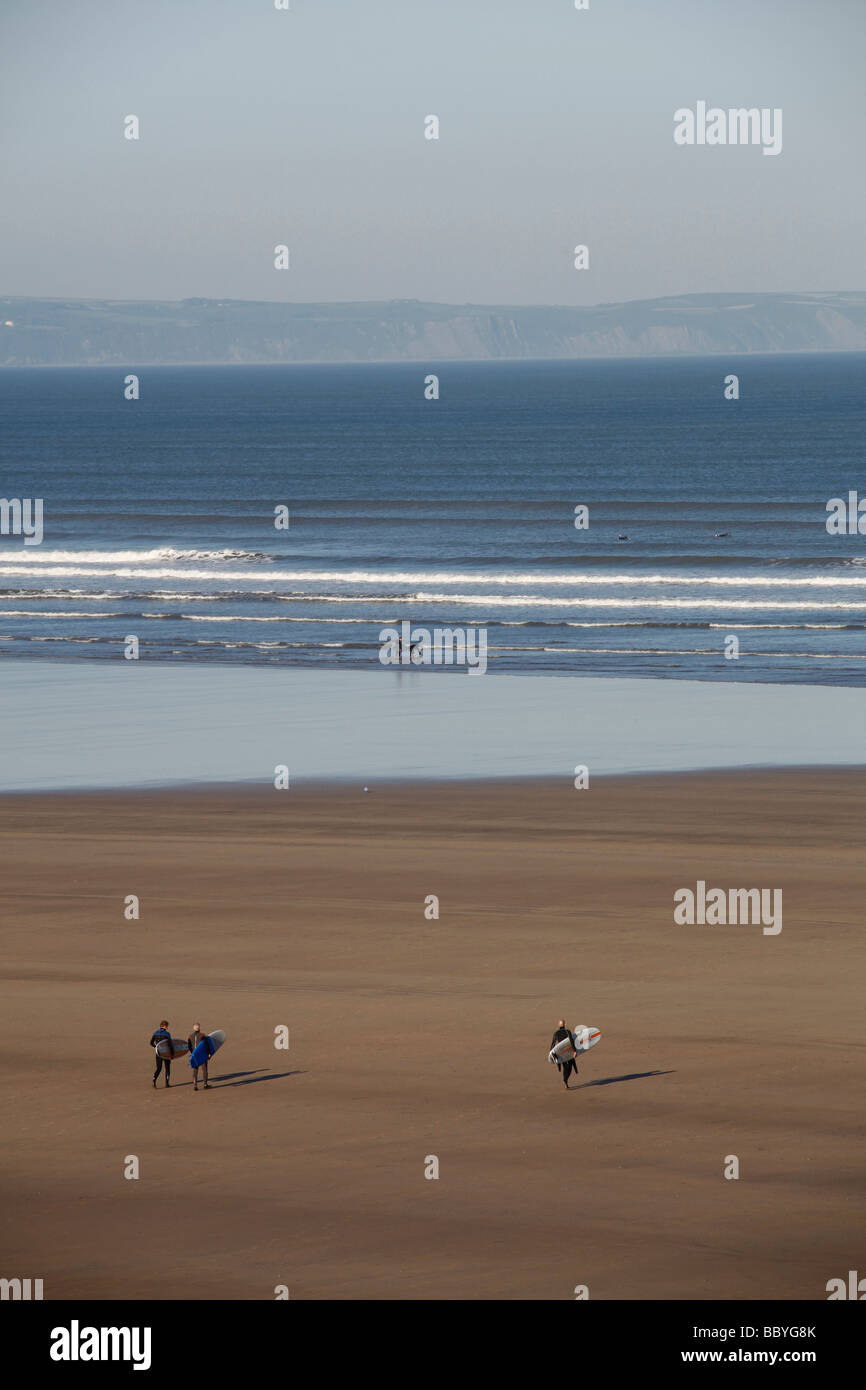 Surfers walking across the beach towards the sea Stock Photo - Alamy