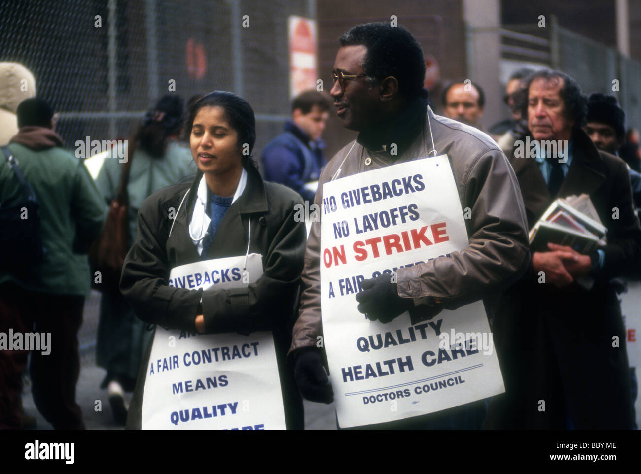 Doctors and other health professionals walk the picket line outside of ...