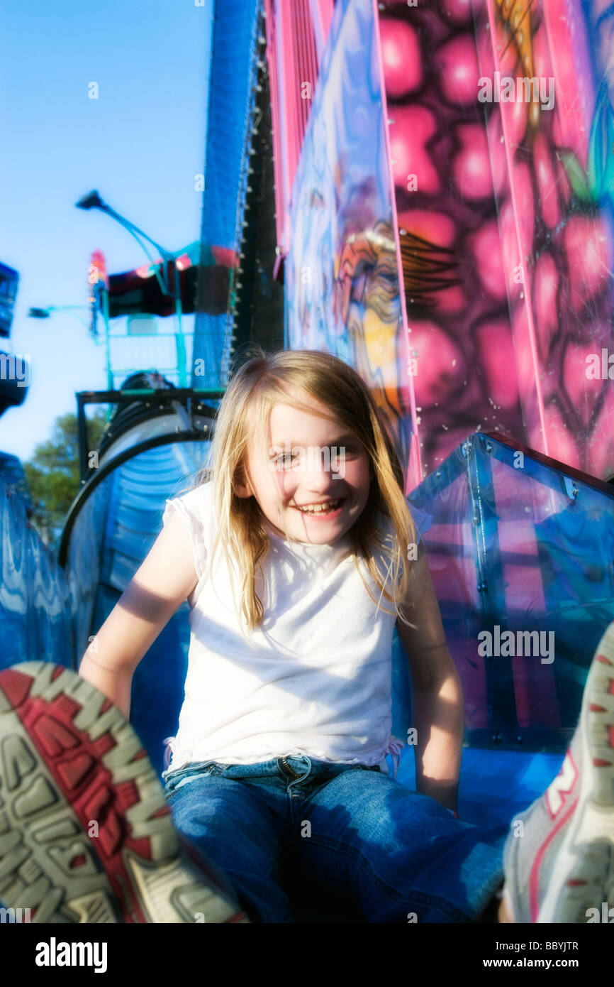 Girl sliding down tube on carnival ride Stock Photo - Alamy