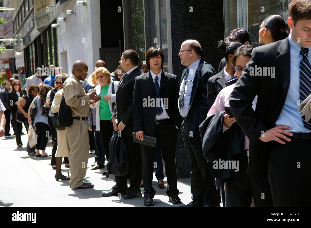 Job seekers line up for a job fair in midtown in New York on Wednesday ...