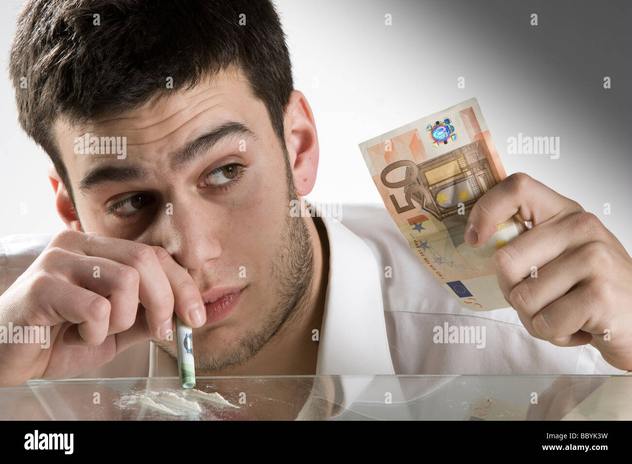 Guy smelling drug on the white background Stock Photo - Alamy