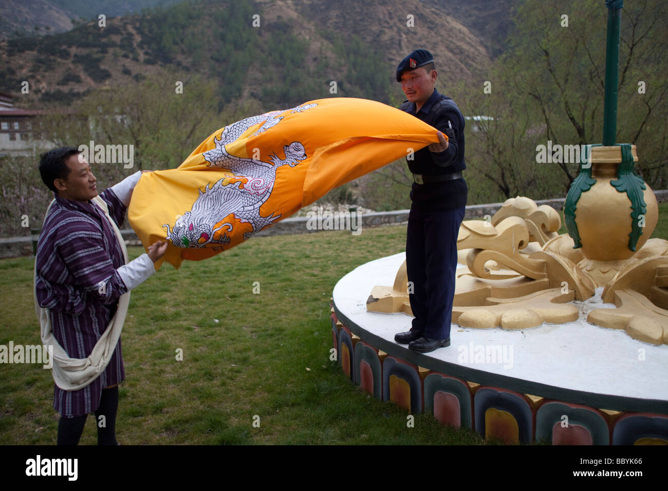 Bhutanese soldier guard folding up Bhutan National Flag at the King's ...