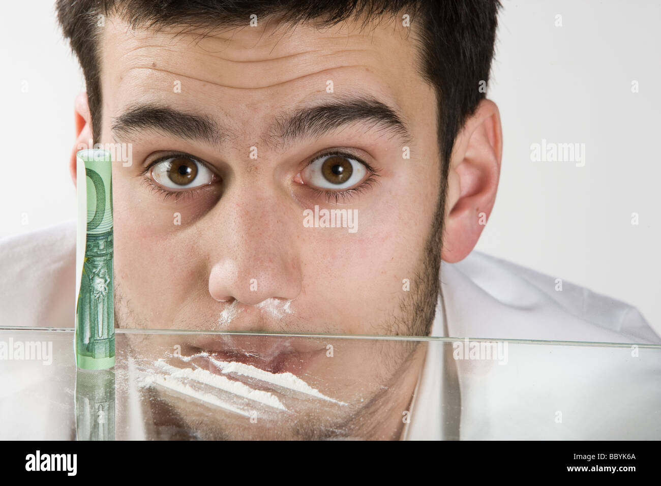 Guy smelling drug on the white background Stock Photo - Alamy