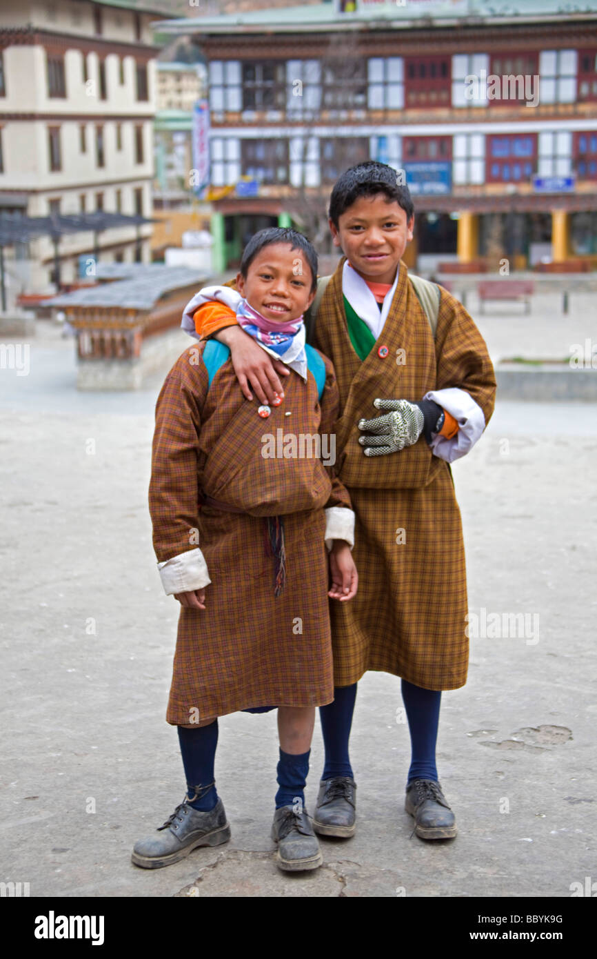Students wearing traditional dress uniform in street in Thimphu Bhutan ...