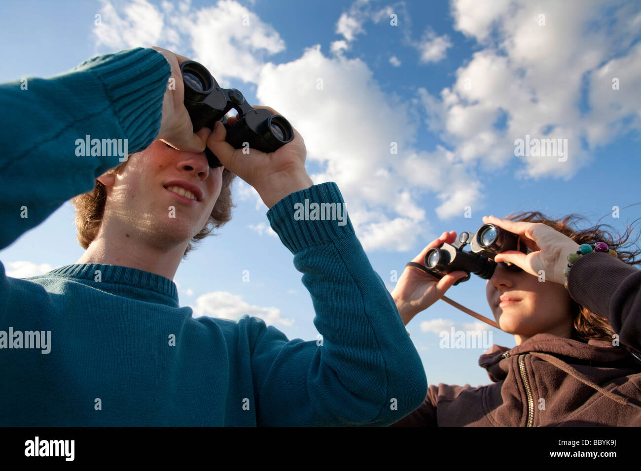 Couple using binoculars Stock Photo - Alamy