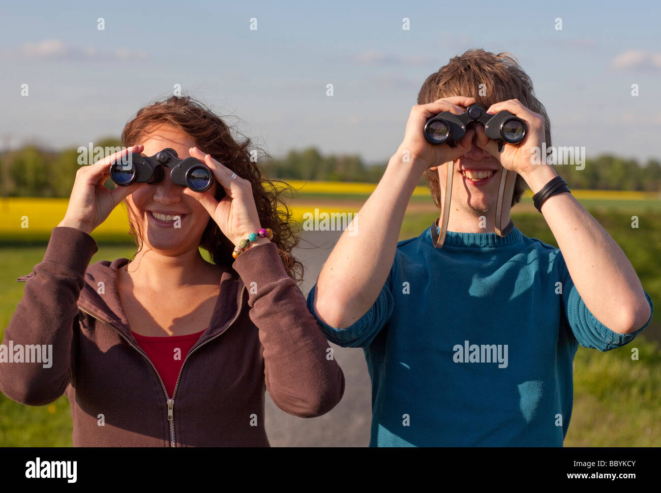 Couple using binoculars Stock Photo - Alamy