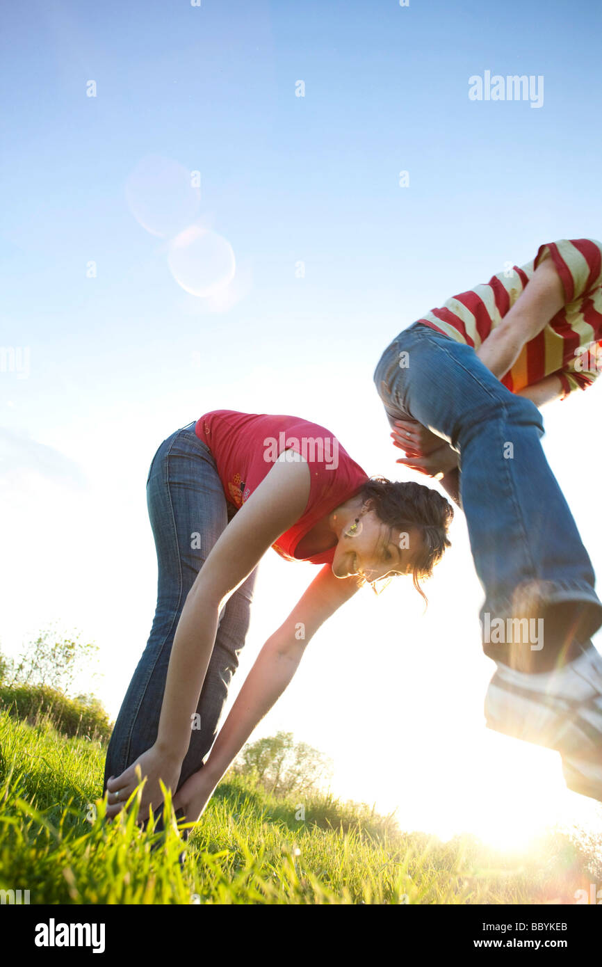 Young couple playing leapfrog Stock Photo - Alamy