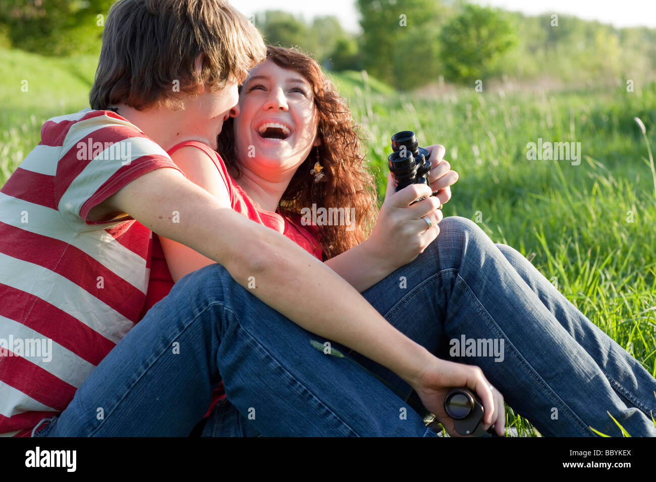 Couple using binoculars Stock Photo - Alamy