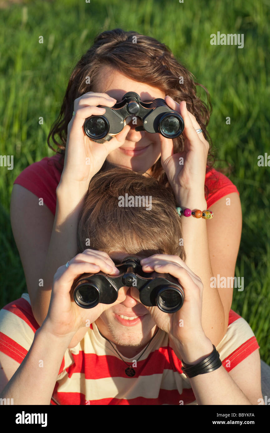 Couple using binoculars Stock Photo - Alamy