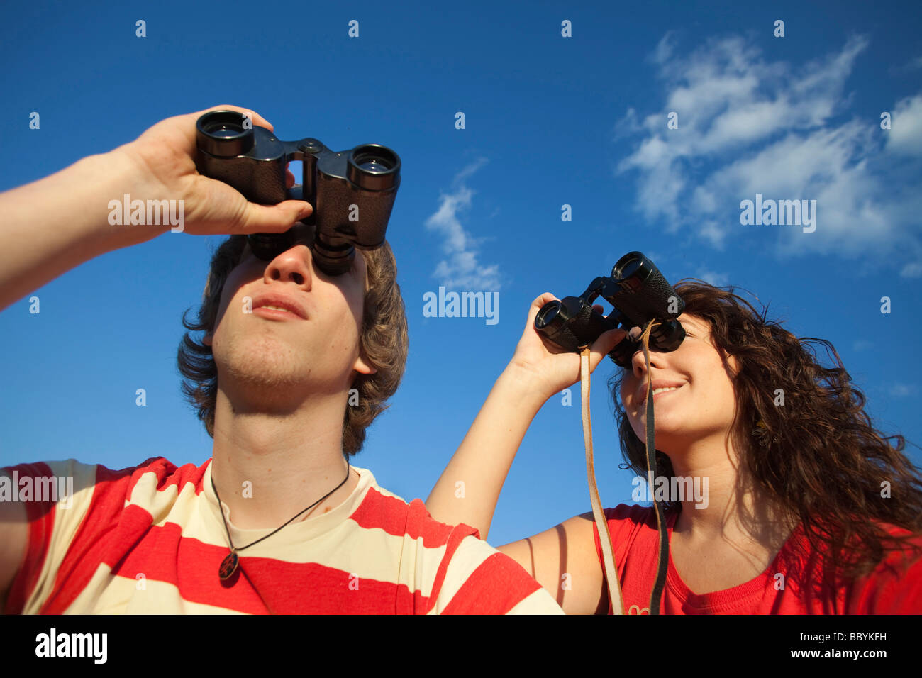 Couple using binoculars Stock Photo - Alamy