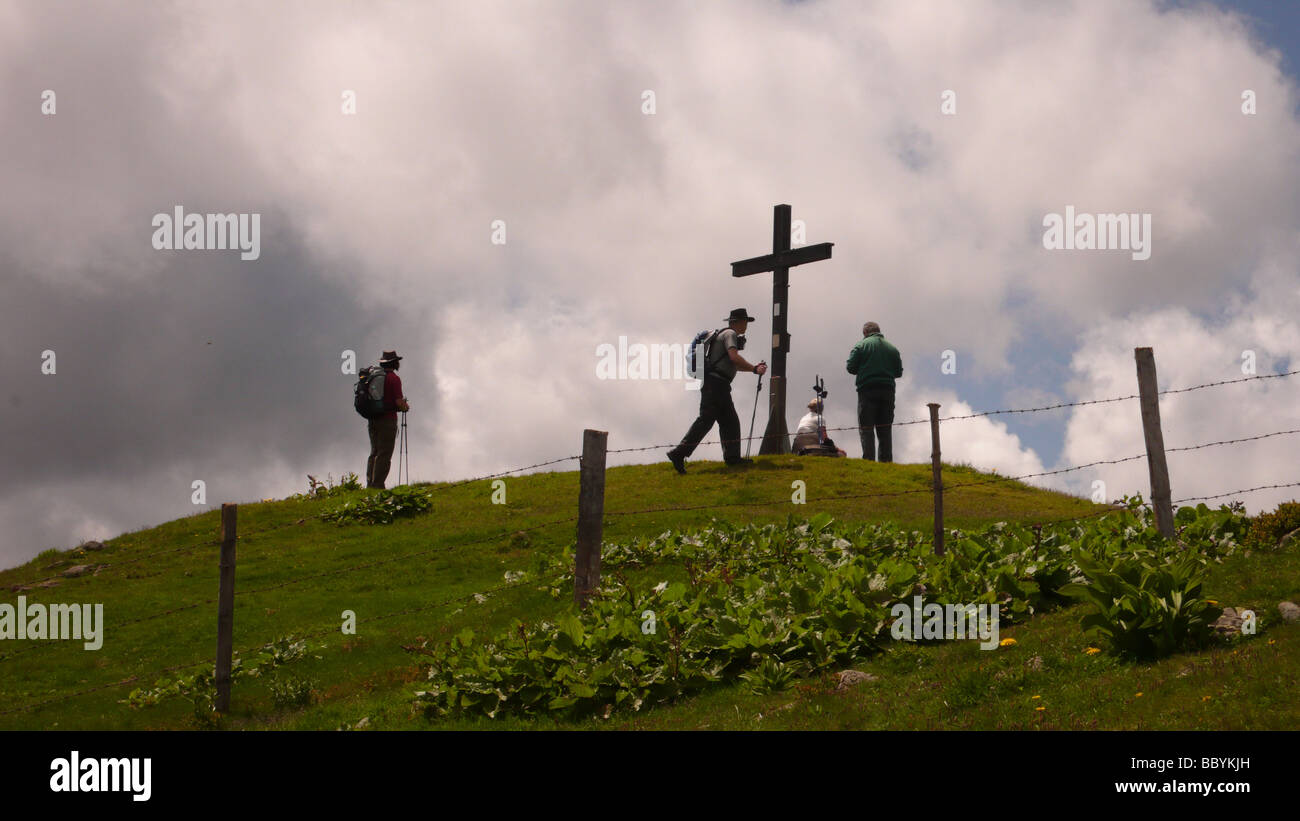 climbes at the cross of the summit of a mountain Stock Photo - Alamy
