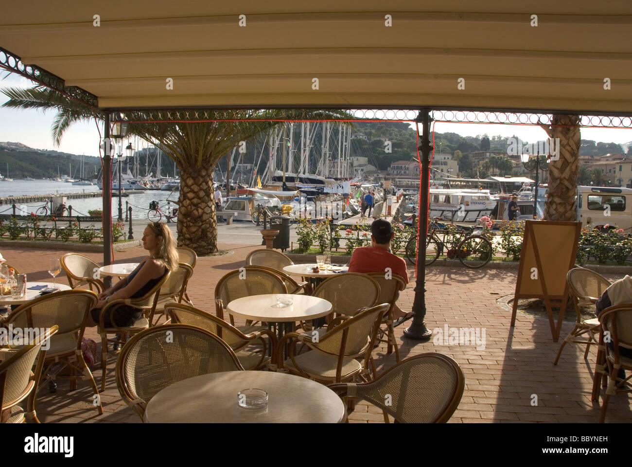 Quayside bar in the marina resort of Porto Azzurro on the Island of ...