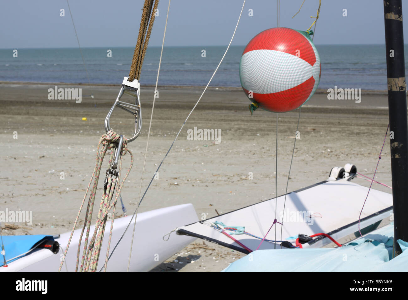 Trapeze ropes with pulley block from a sail boat on a beach Stock Photo ...