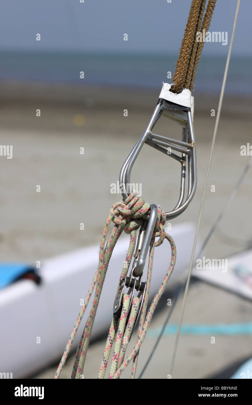 Trapeze ropes with pulley block from a sail boat on a beach Stock Photo ...