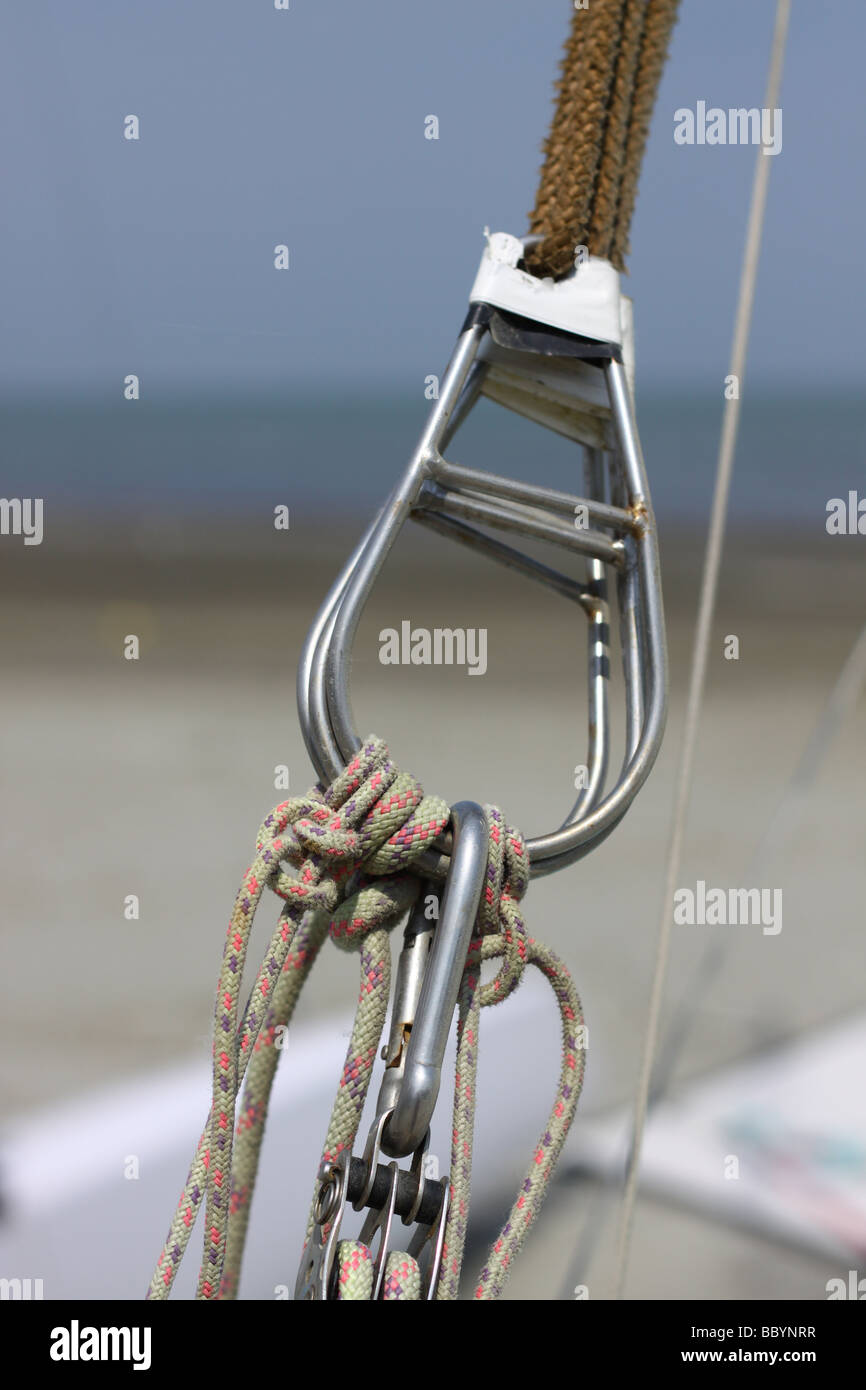 Trapeze ropes with pulley block from a sail boat on a beach Stock Photo ...