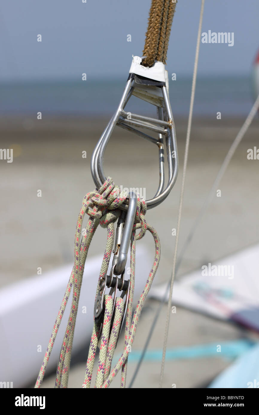 Trapeze ropes with pulley block from a sail boat on a beach Stock Photo ...