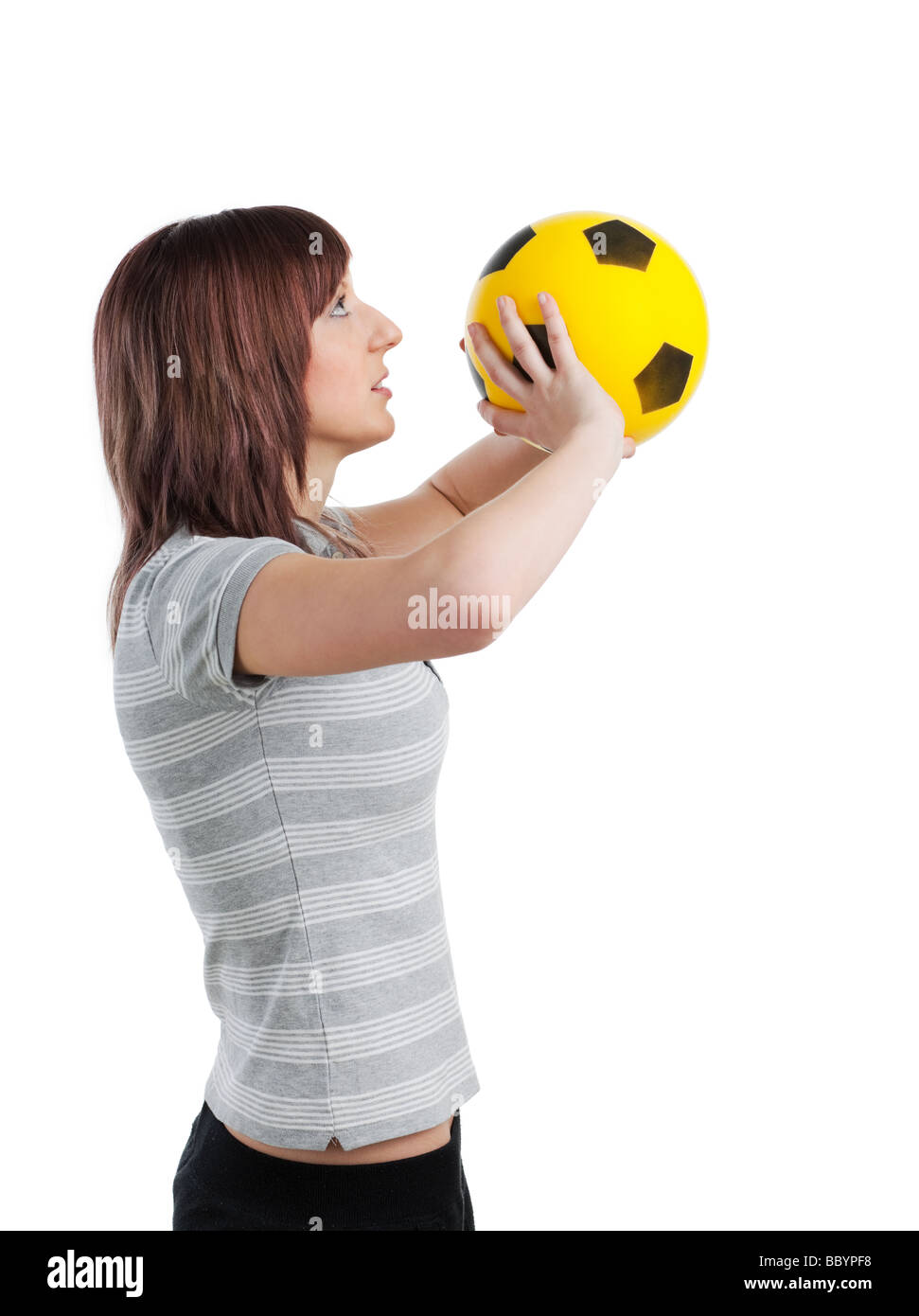 Teenager girl throwing yellow ball isolated on white Stock Photo - Alamy