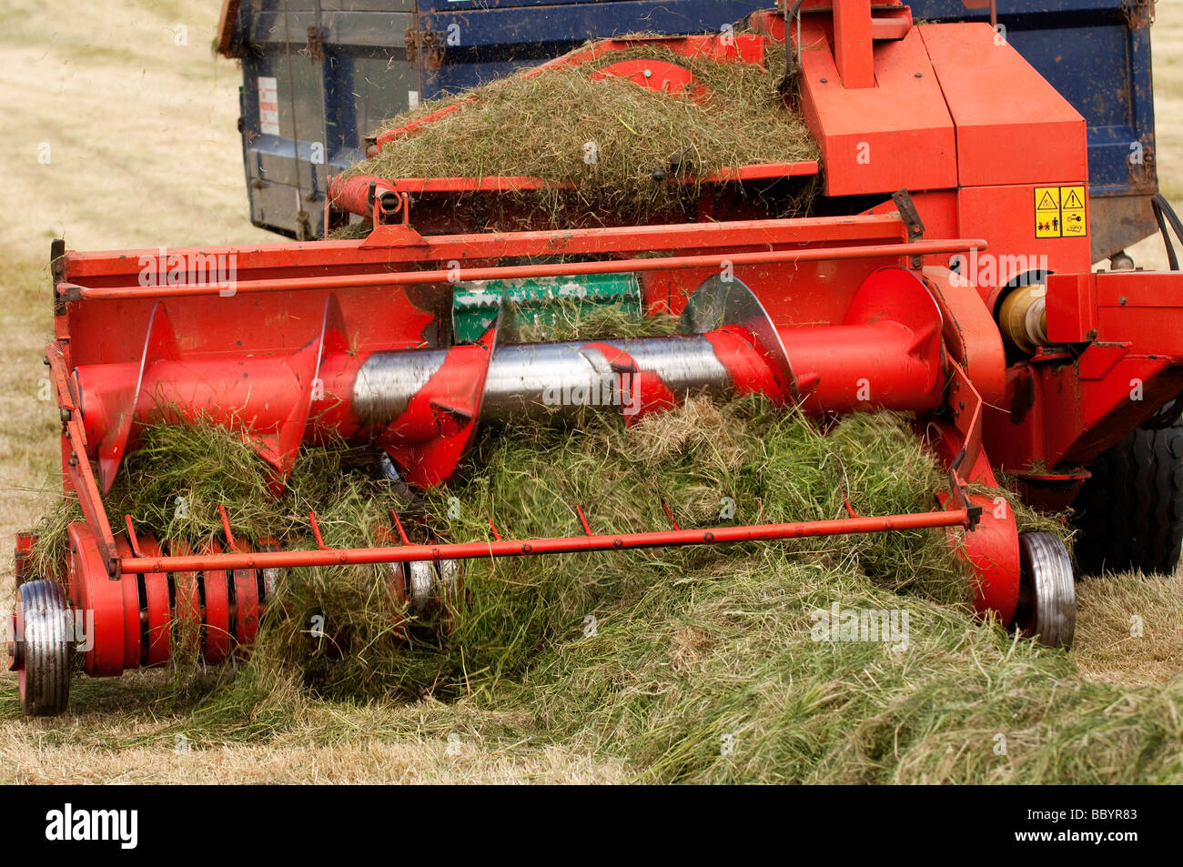 pick up reel on a trailed forage harvester picking up grass and loading ...