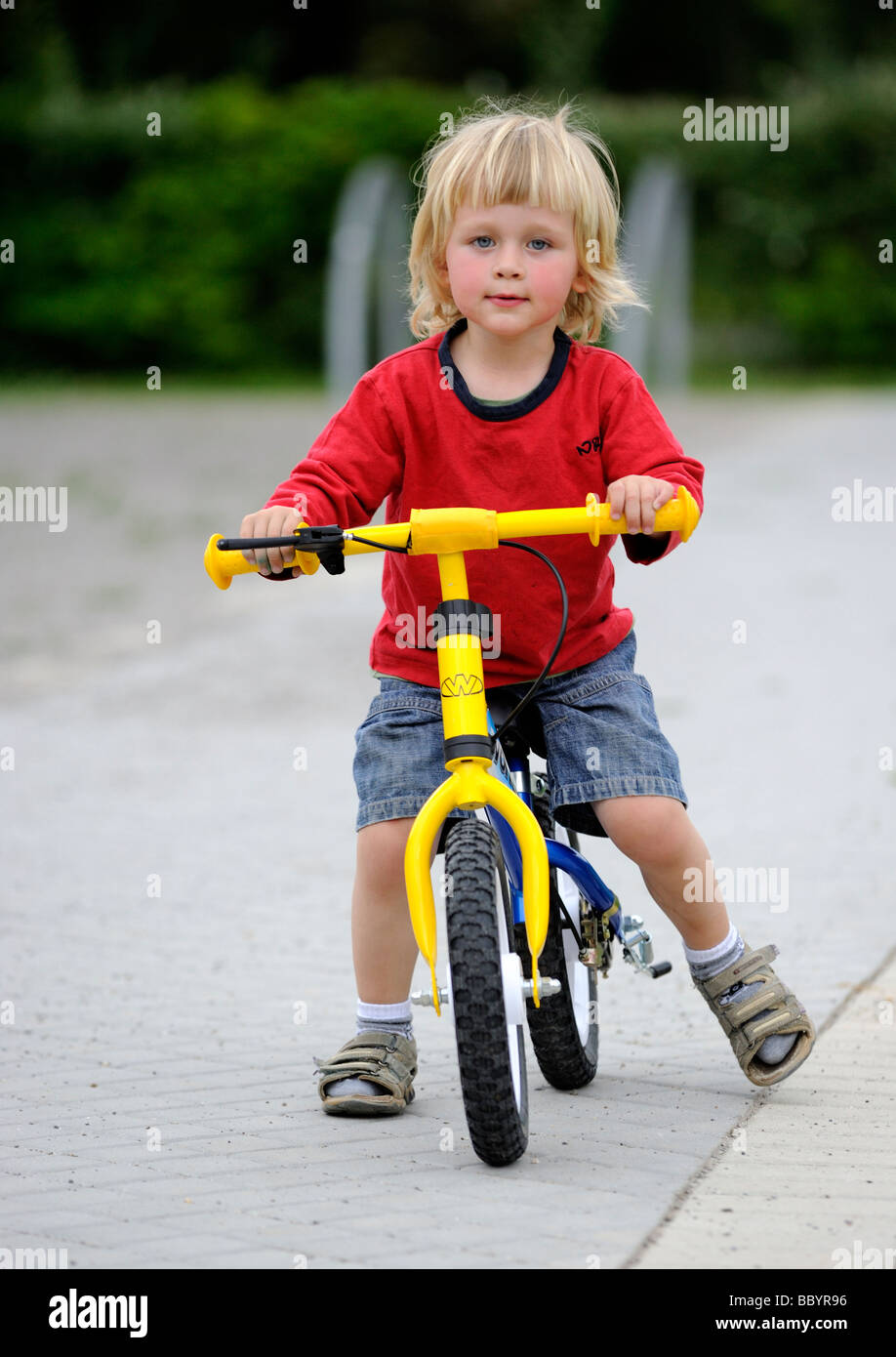 Little boy riding a bounce bicycle Stock Photo - Alamy