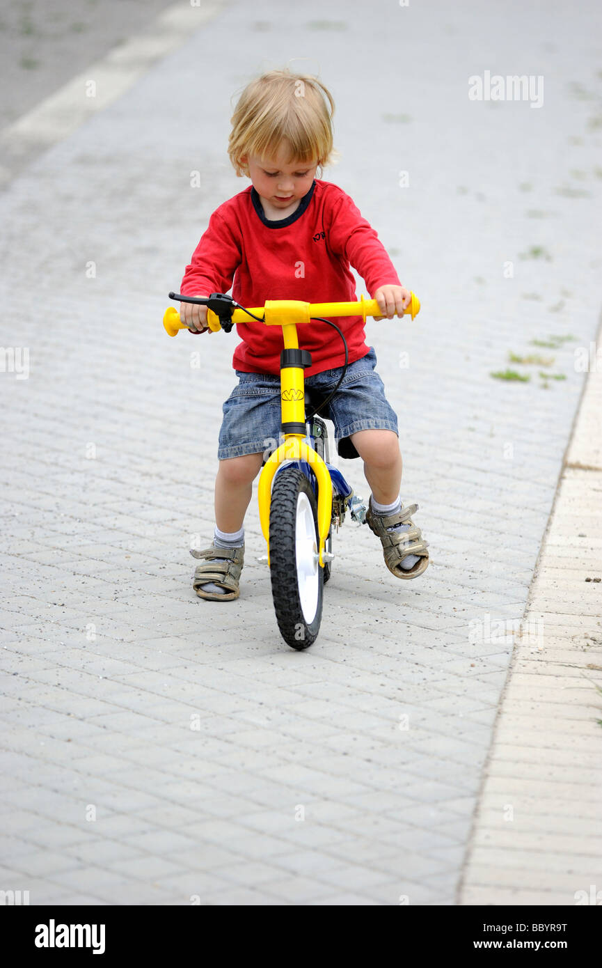Little boy riding a bounce bicycle Stock Photo - Alamy
