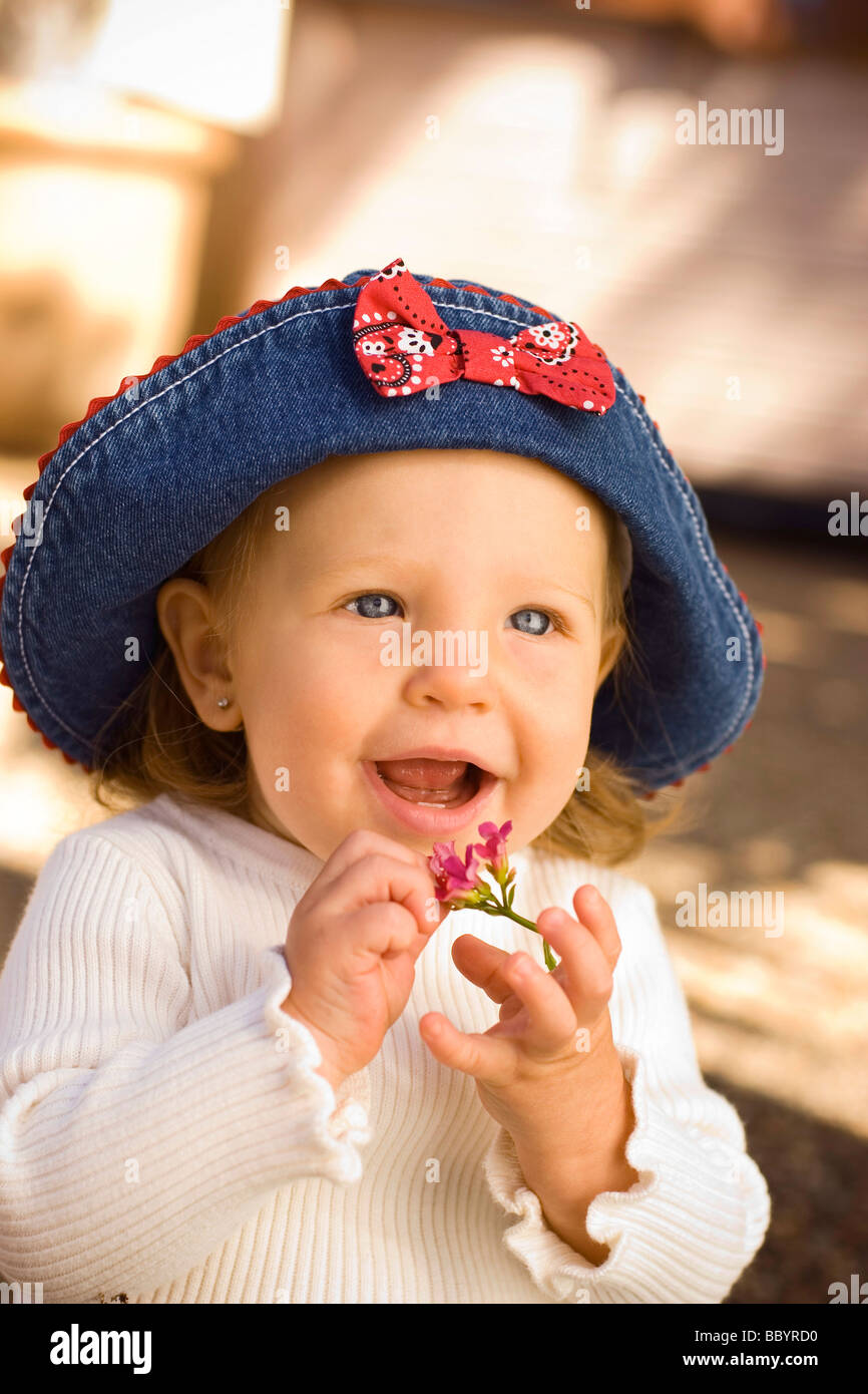 infant holding flower Stock Photo - Alamy