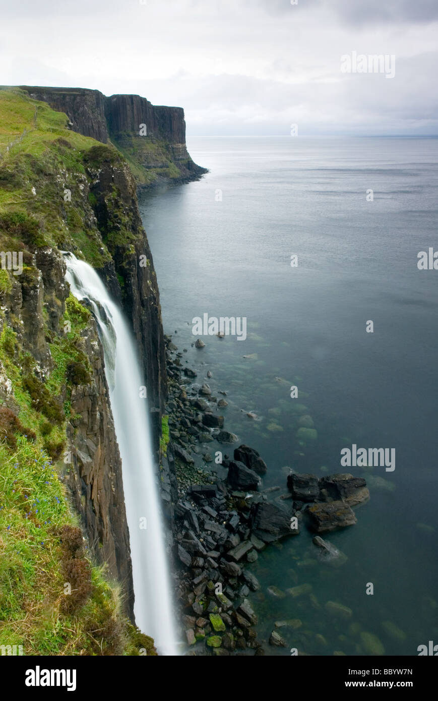 Waterfall flowing over the cliffs of the coast of Isle of Skye Scotland ...