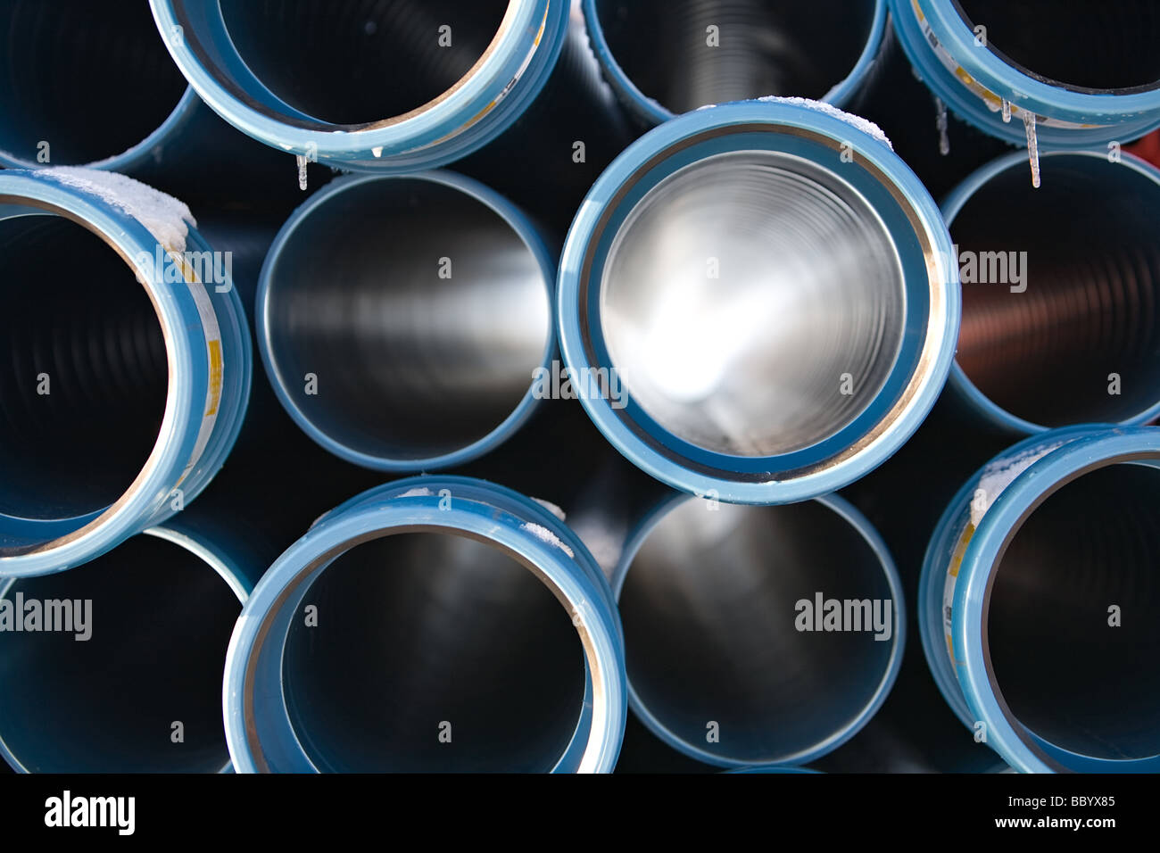blue pipes stacked in construction site pattern closeup Stock Photo - Alamy