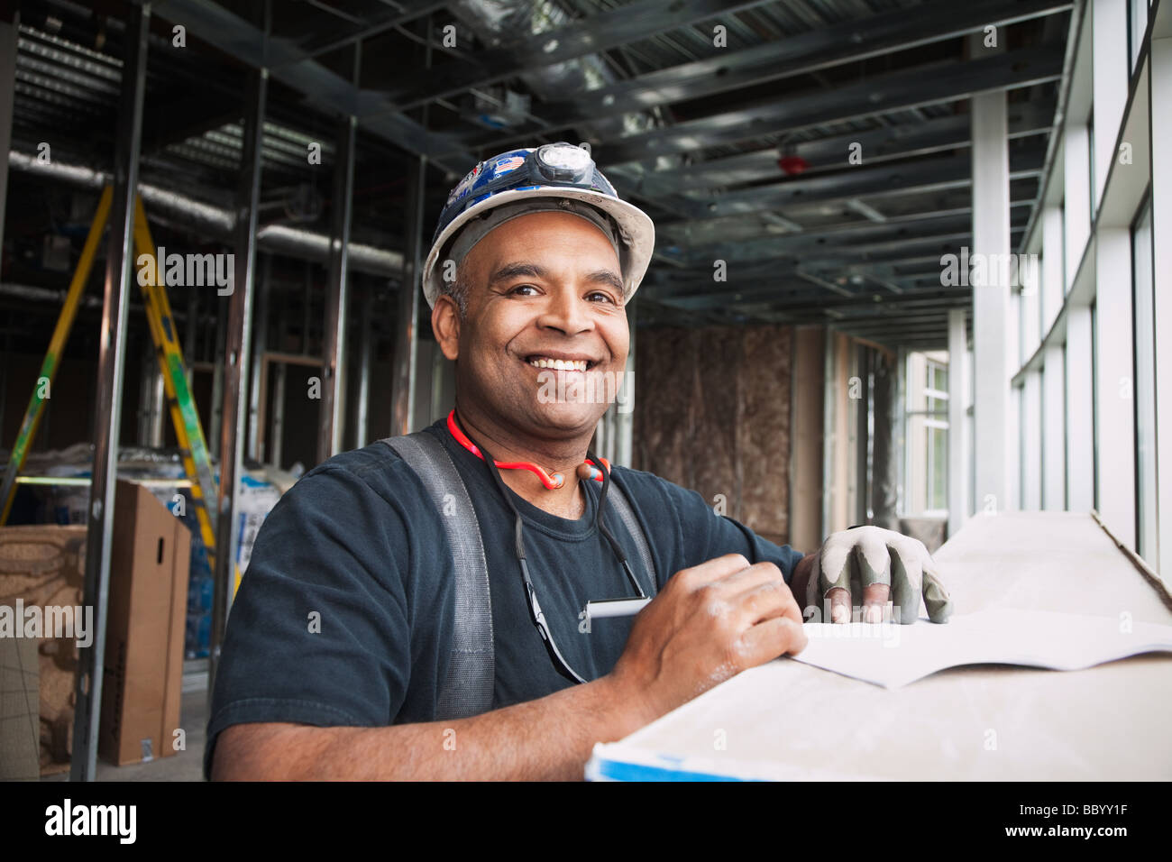 Mixed race worker on construction site Stock Photo - Alamy