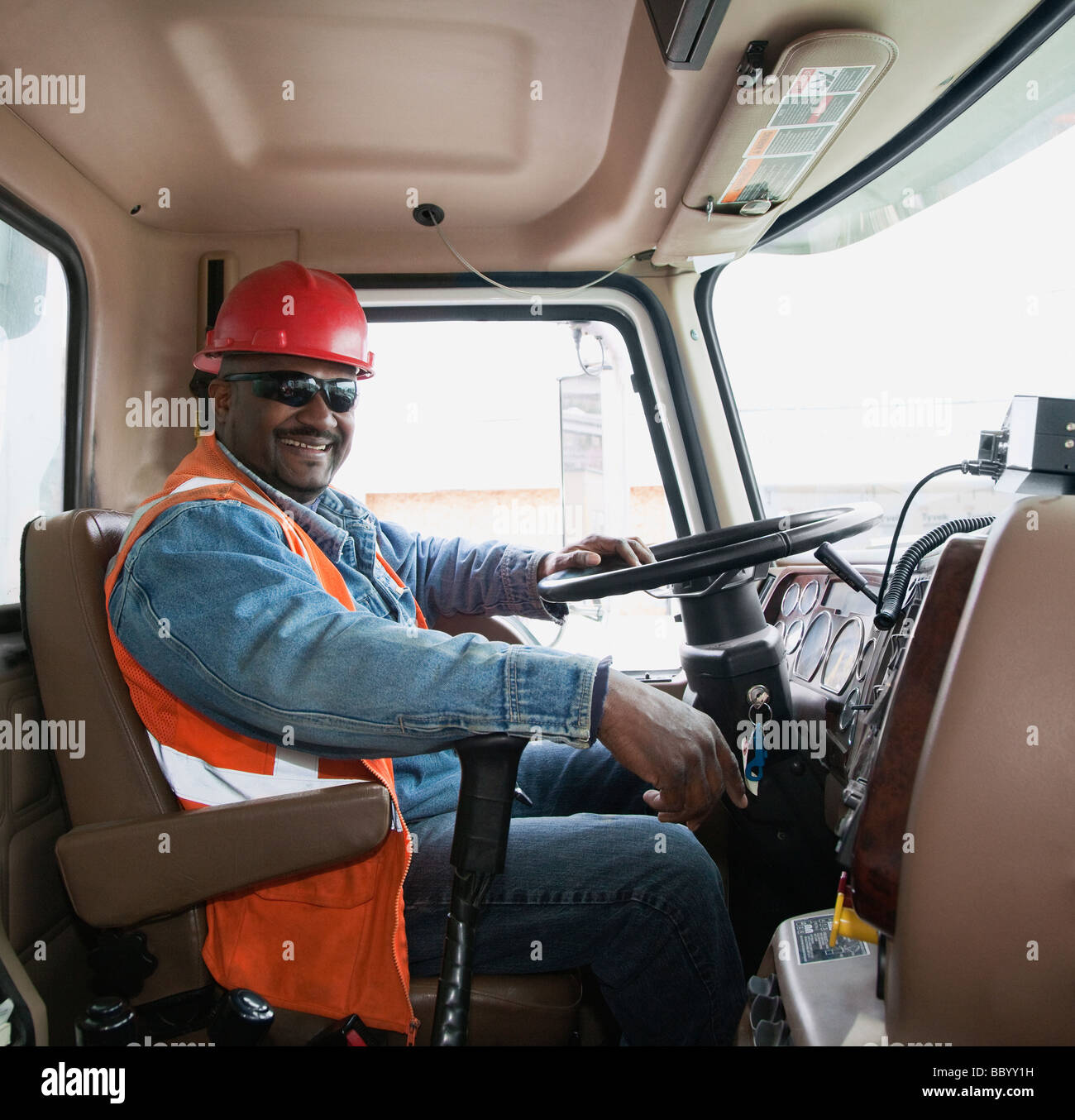 African construction worker driving truck Stock Photo - Alamy