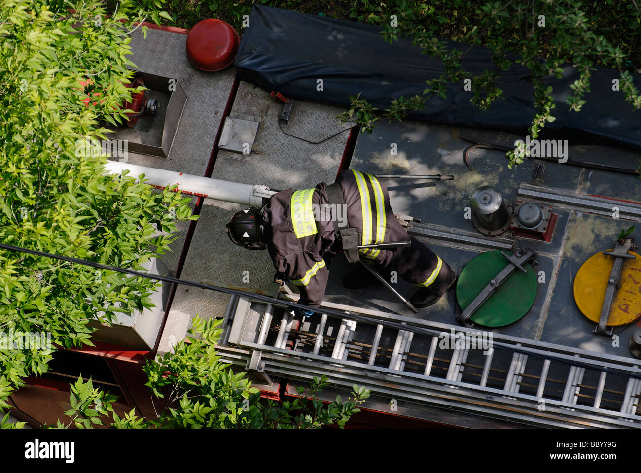 The fireman on a roof of the fire machine prepares for fire ...