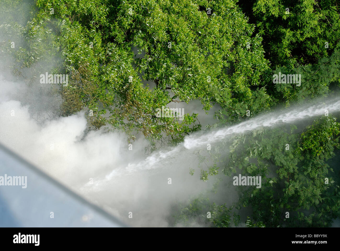 Extinguishing of fire by water jet Stock Photo - Alamy