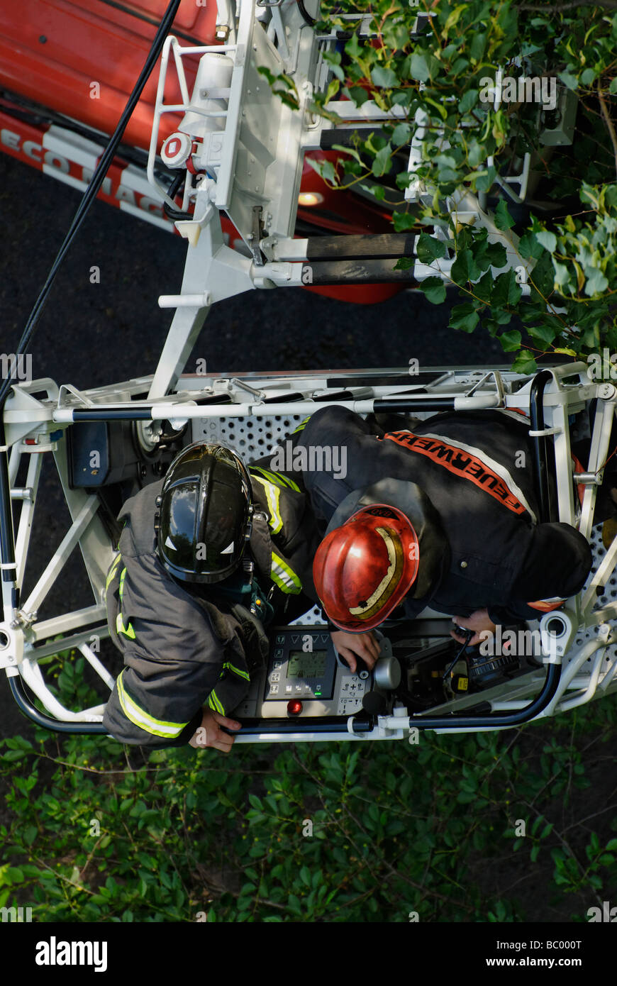 Two firemen in aerial platform of fire engine Stock Photo - Alamy