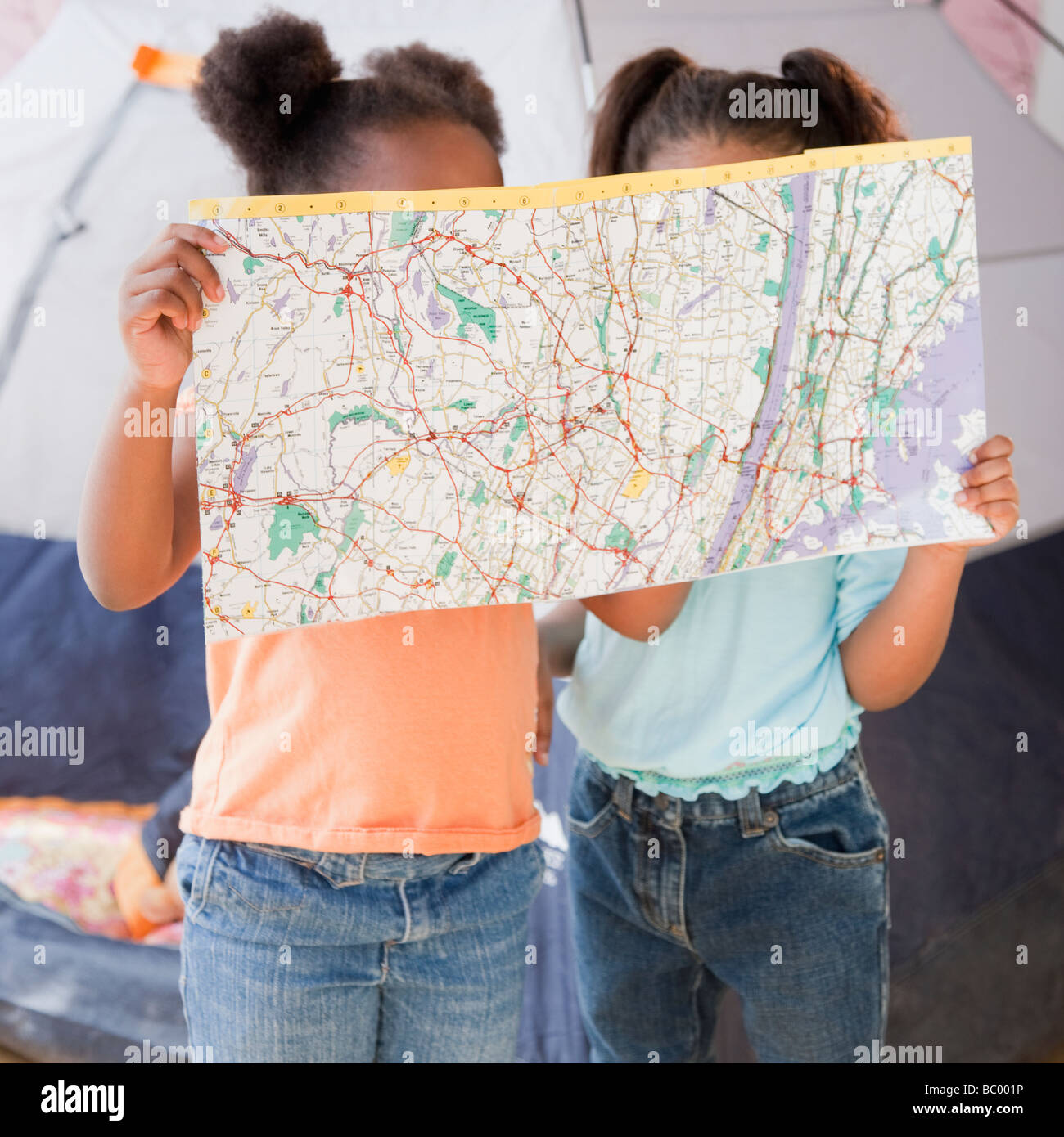 African girls looking at map Stock Photo - Alamy