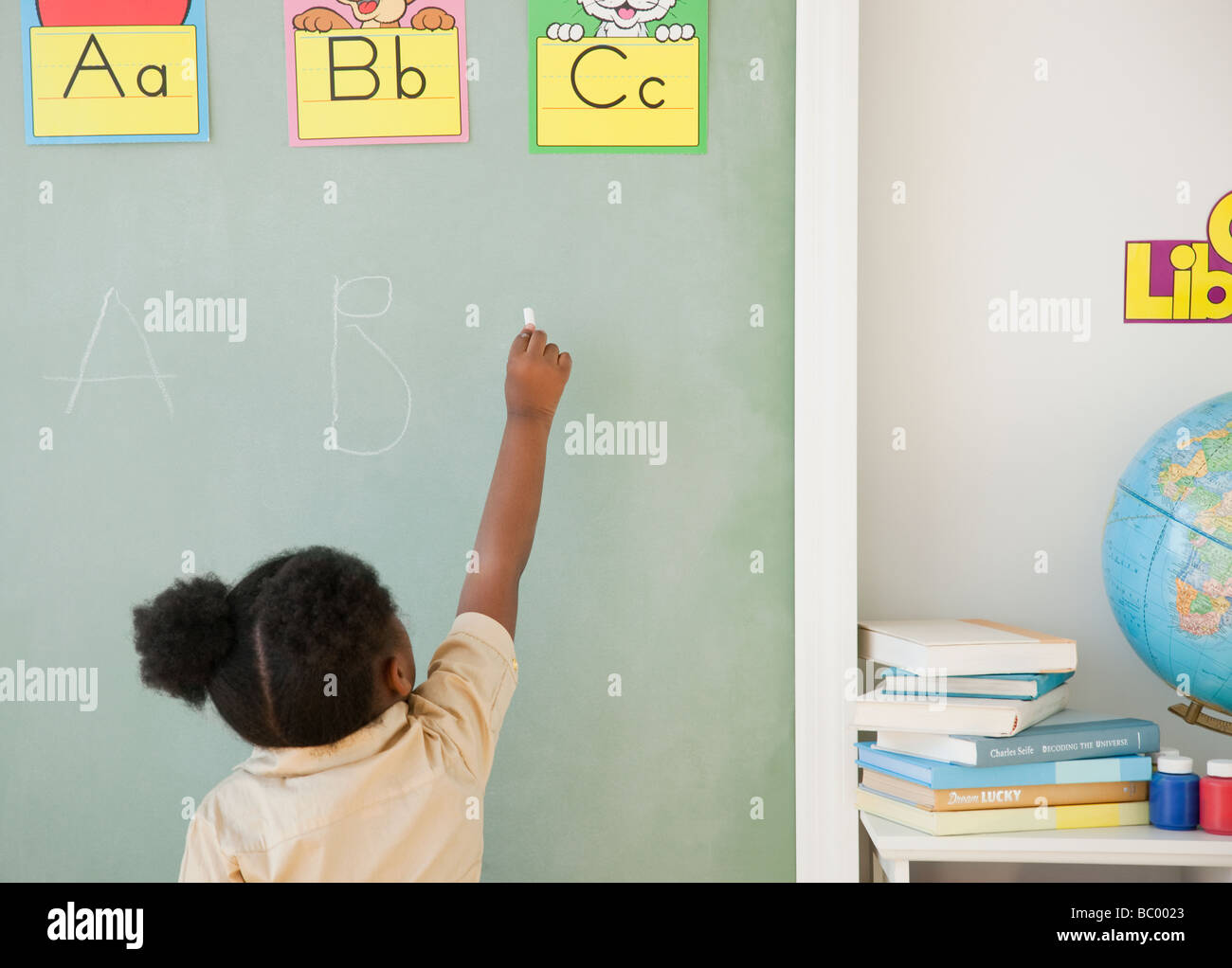 African girl writing on blackboard Stock Photo - Alamy