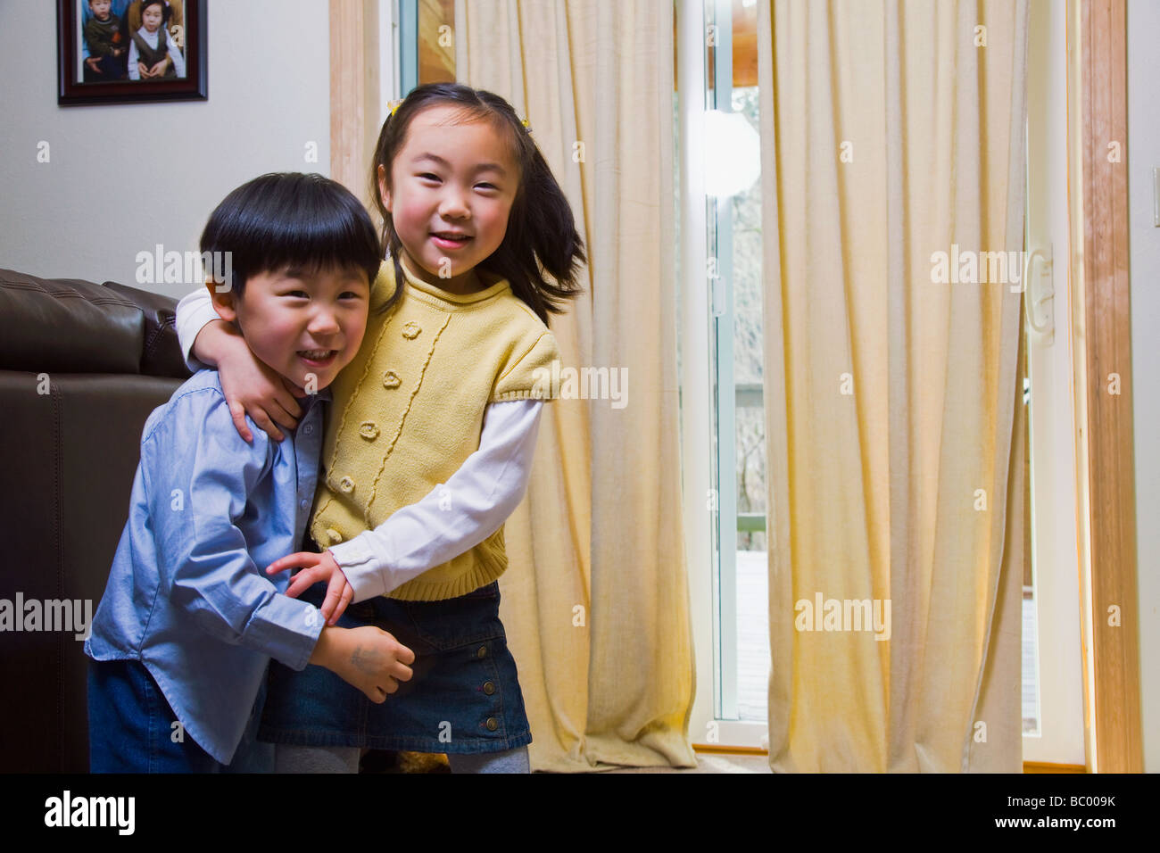 Korean brother and sister hugging Stock Photo - Alamy