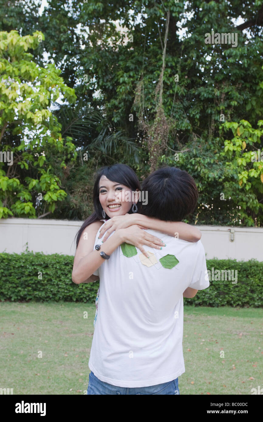 Asian couple hugging outdoors Stock Photo - Alamy