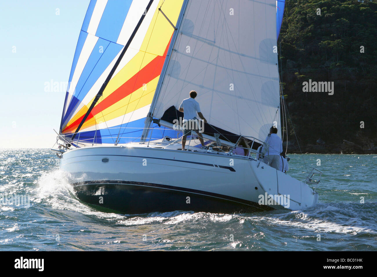Trimming the spinnaker sail on a yacht cruising on the North Shore from ...