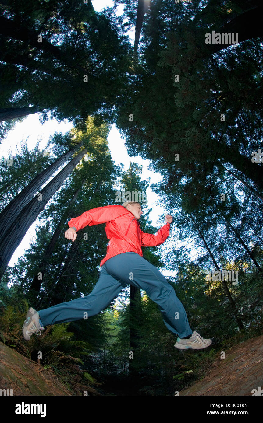 Woman running jumping ditch hi-res stock photography and images - Alamy