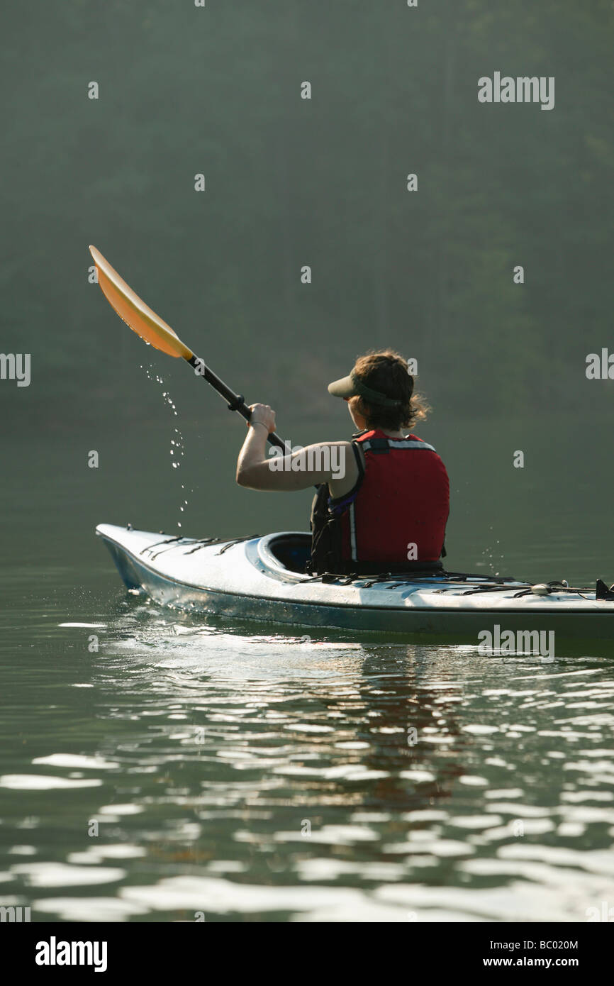 Female kayaker on a lake Stock Photo - Alamy
