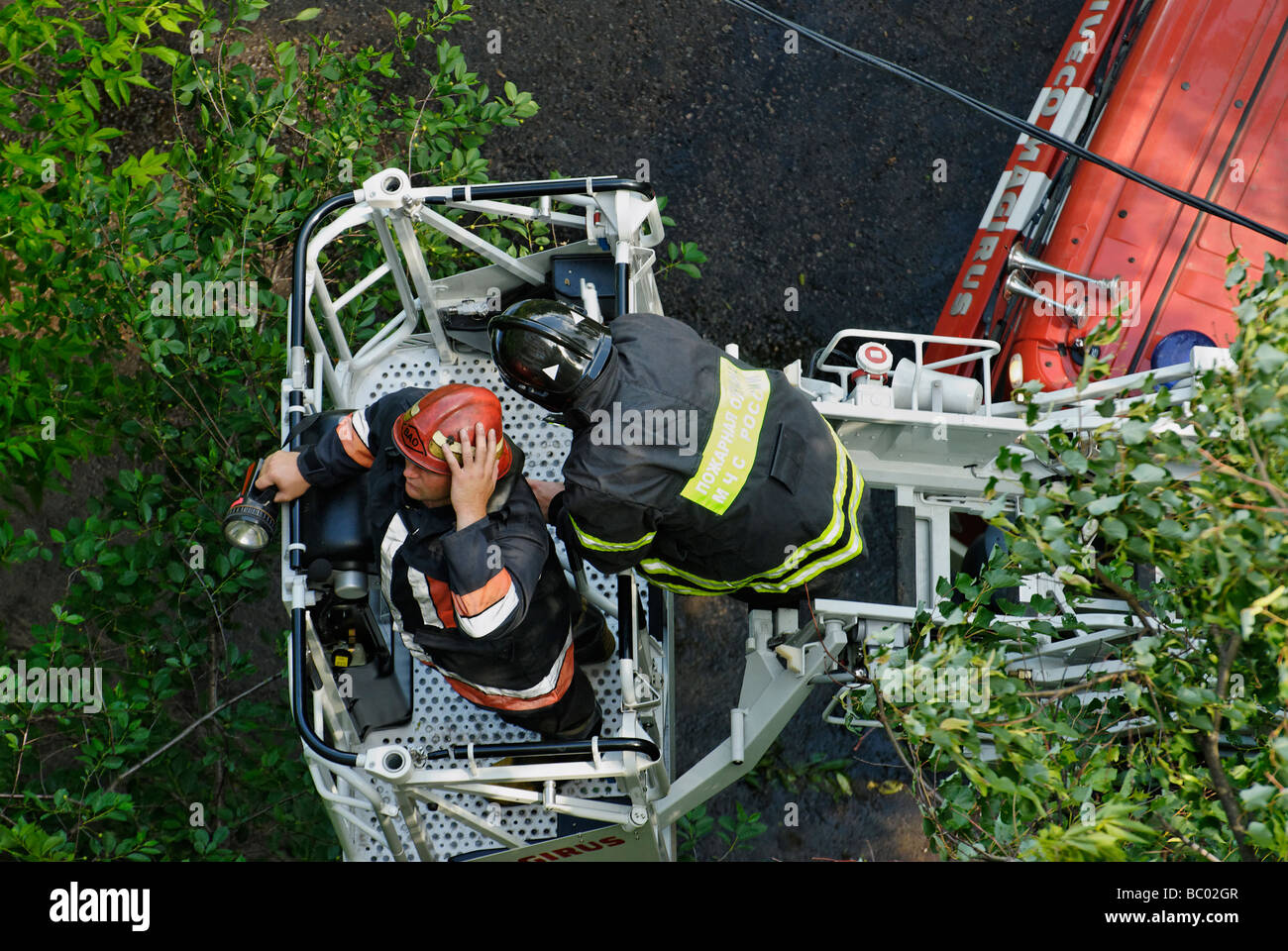 Two firemen in aerial platform of fire engine Stock Photo - Alamy