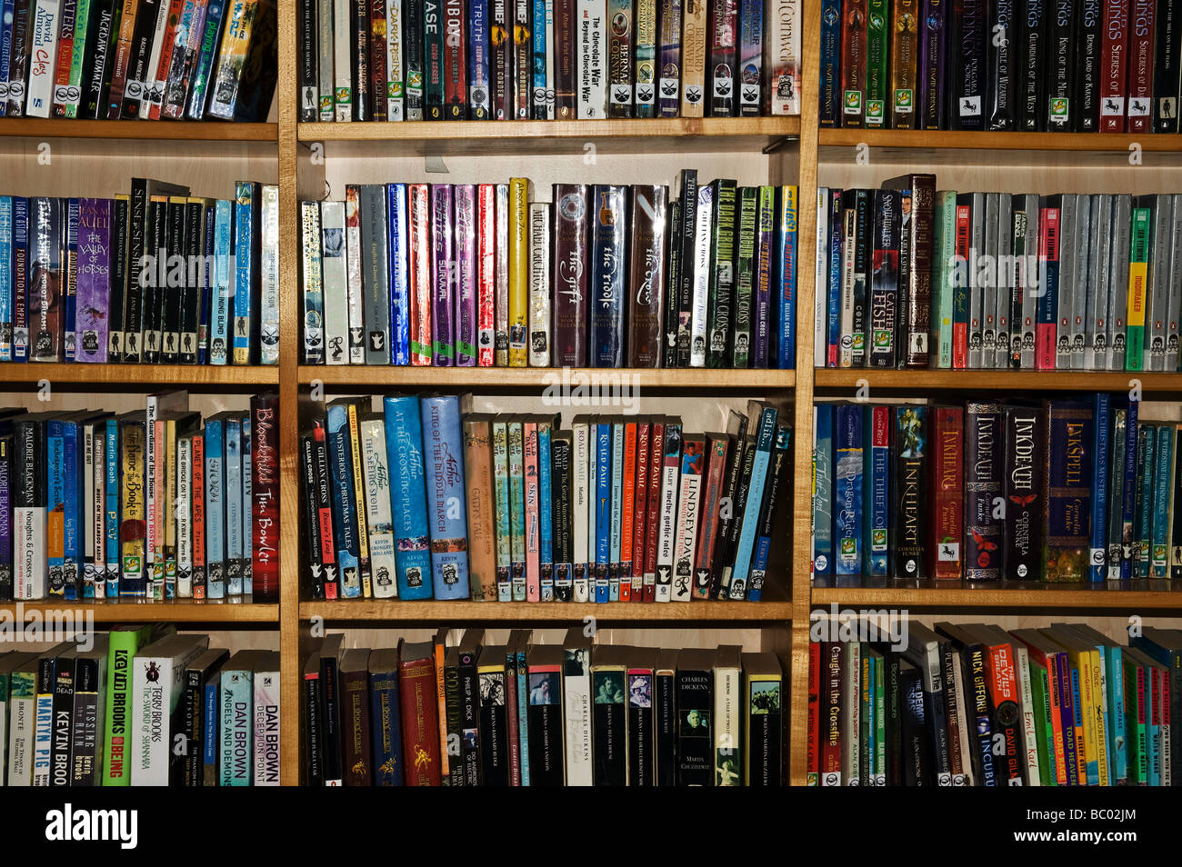 Books stacked on shelves Stock Photo - Alamy