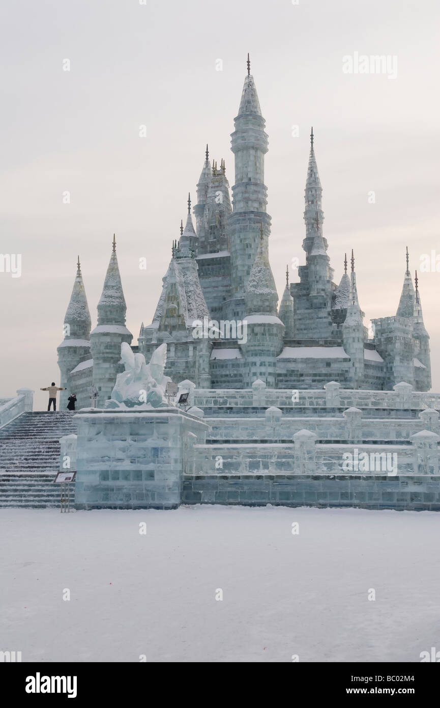 Tourists posing for a photo on an ice castle in Harbin, China Stock ...